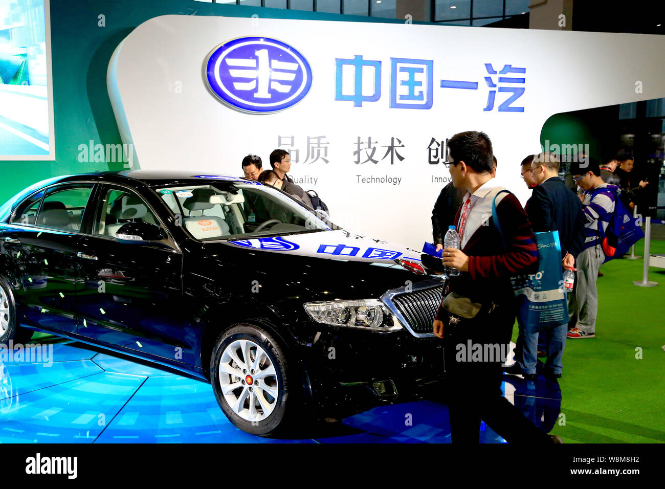 --FILE--Visitors look at a Hongqi (Red Flag) car of FAW on display ...