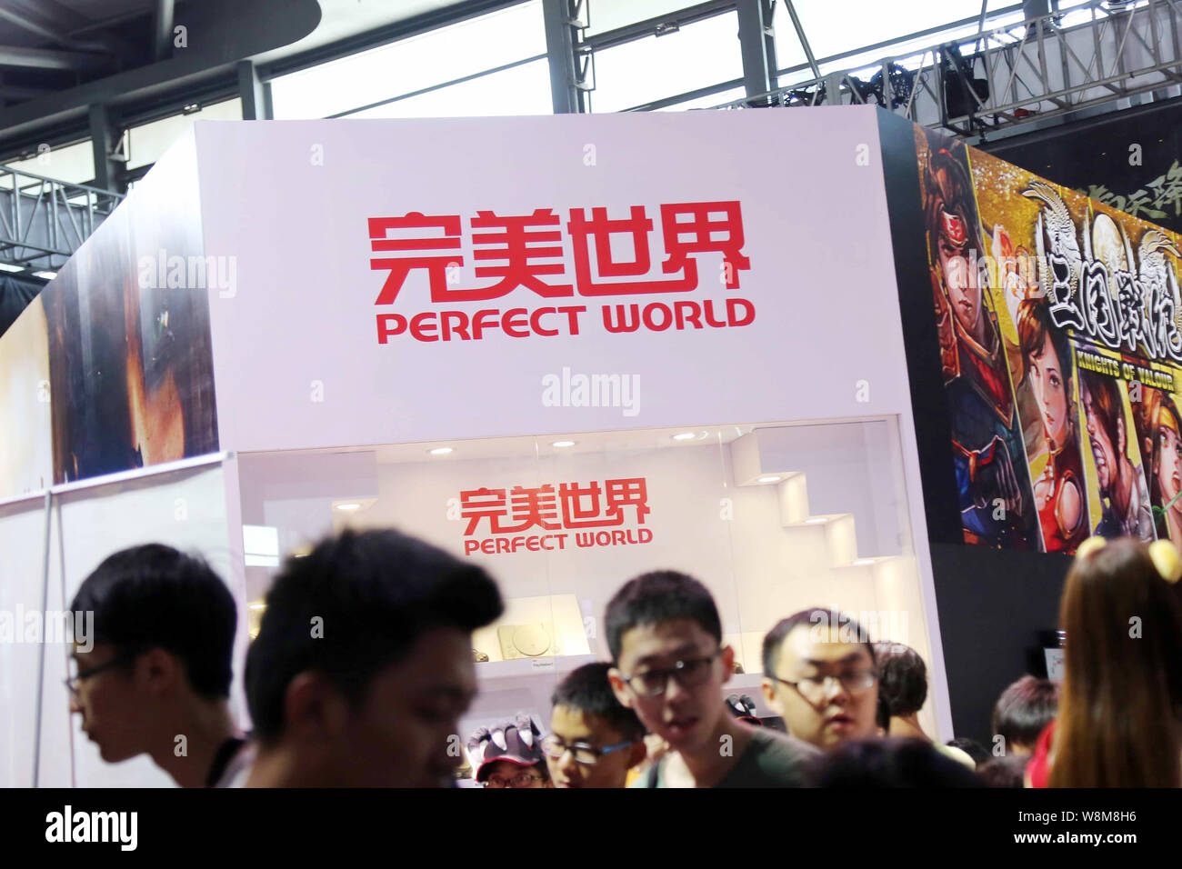 --FILE--Visitors walk past the stand of online game developer and ...