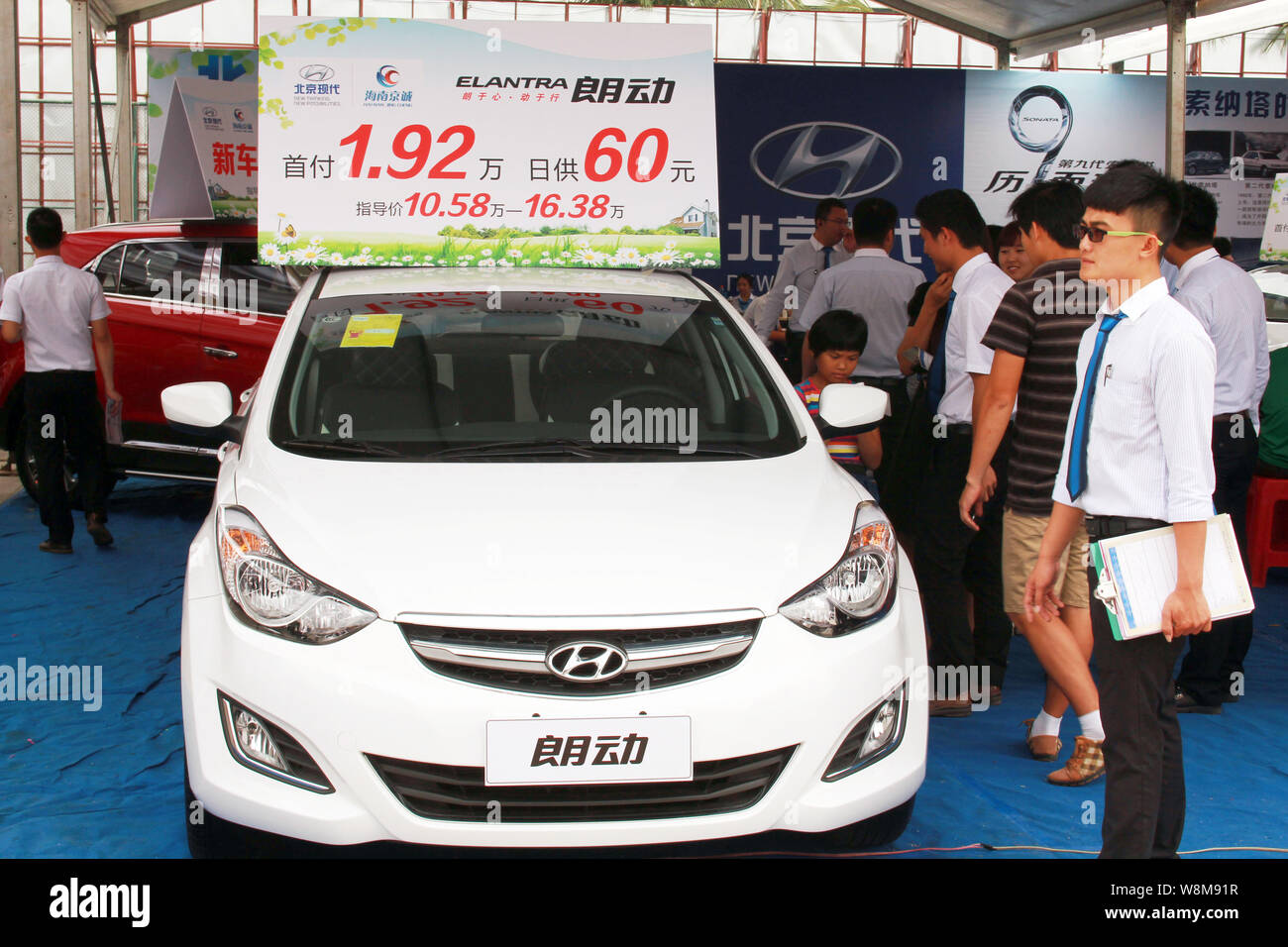 --FILE--Visitors look at Hyundai cars on display during an auto show in ...