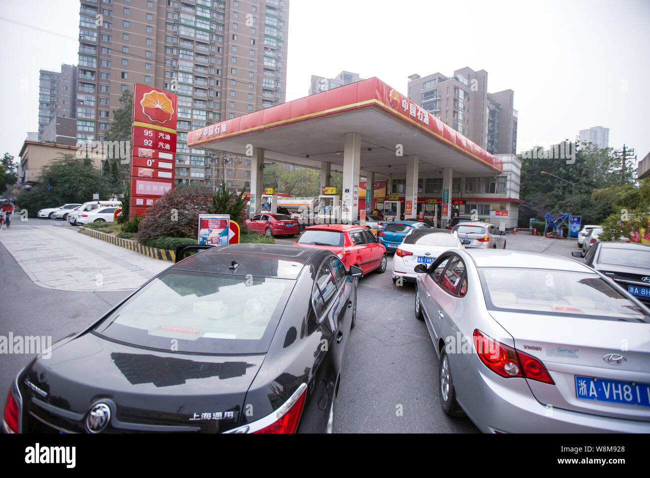 --FILE--Cars to be refueled line up at a gas station of PetroChina, a ...