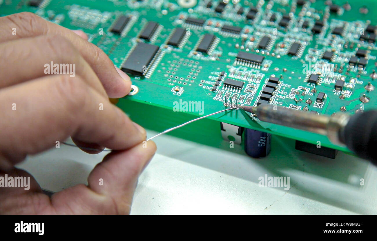manual electronics soldering and oscilloscope testing Stock Photo - Alamy