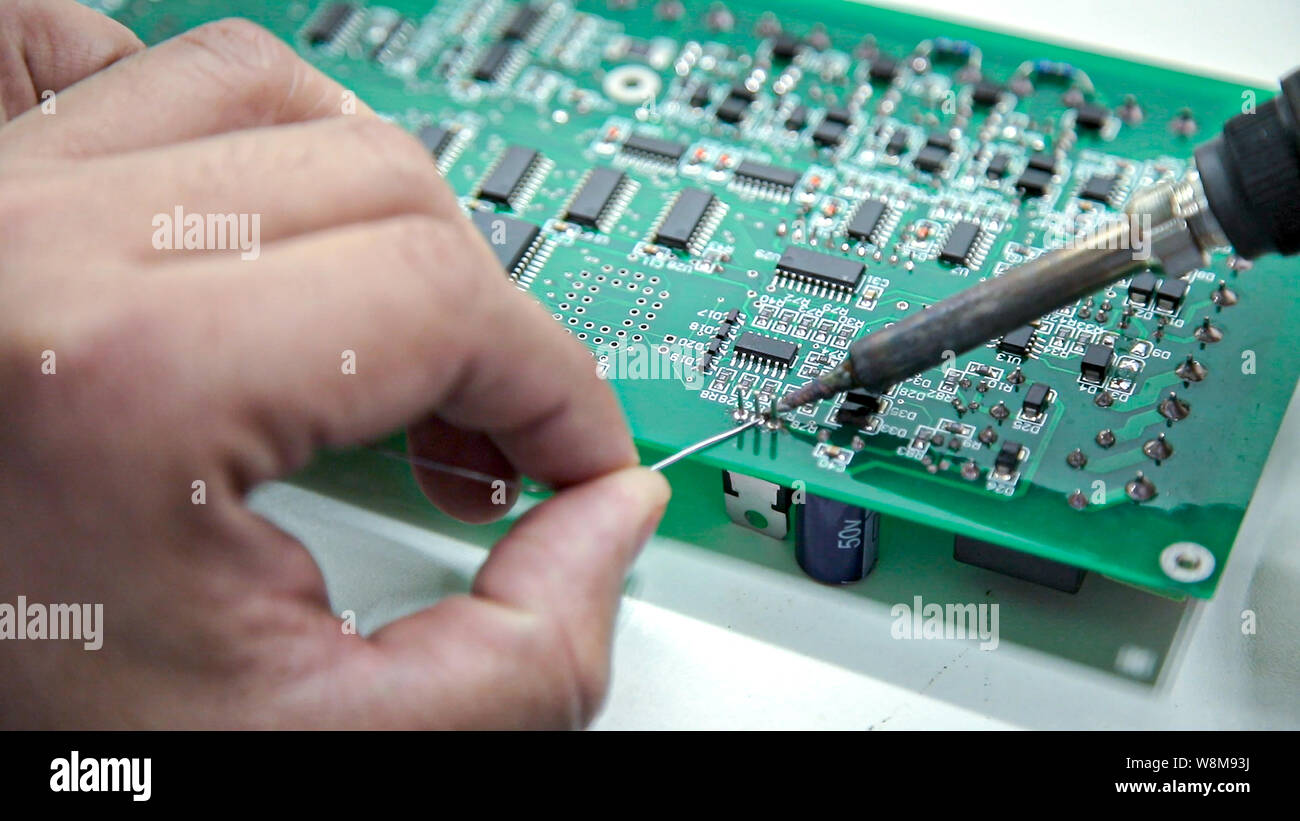 manual electronics soldering and oscilloscope testing Stock Photo - Alamy