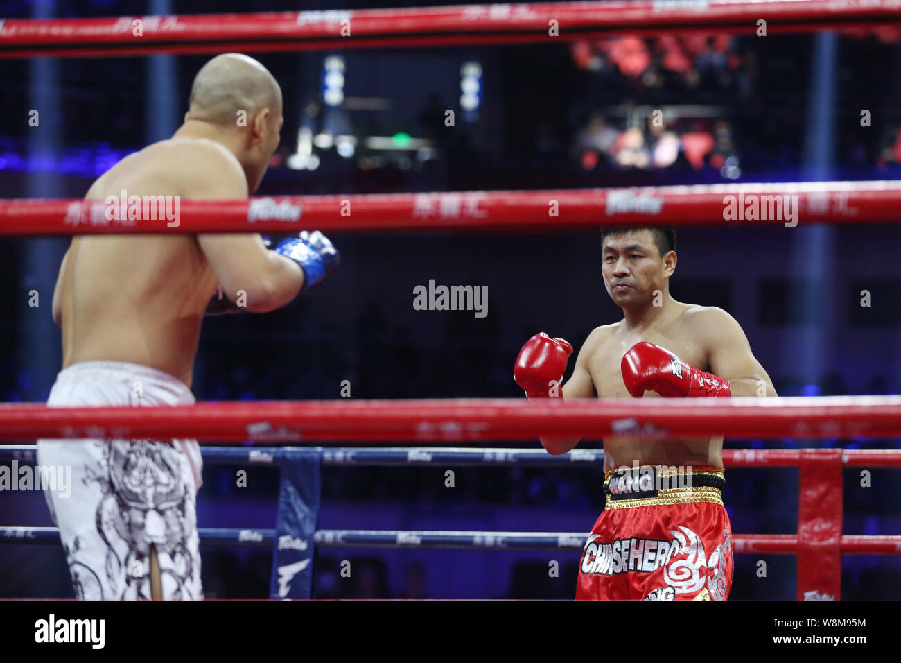 Chinese boxer Wang Hongxiang, right, fights Japanese boxer KING in ...