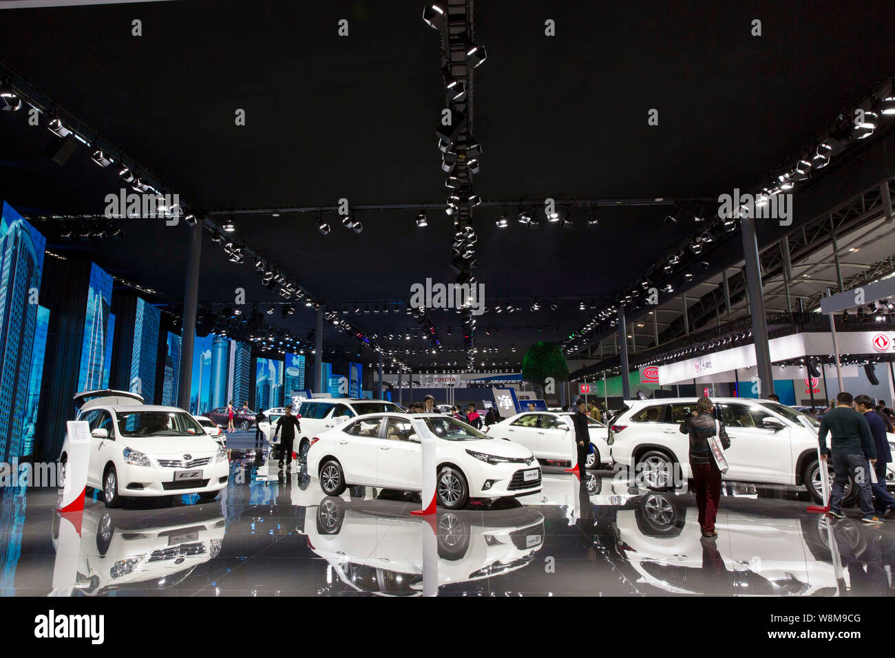 --FILE--Visitors try out or look at Toyota cars on display during the ...
