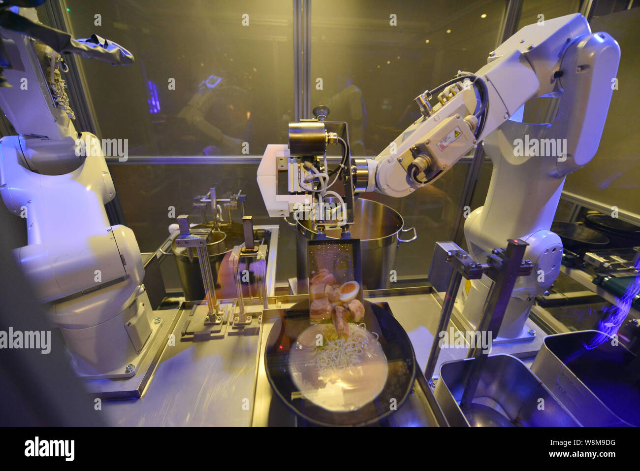 Robots Koya and Kona cook a bowl of noodles at a ramen restaurant in ...