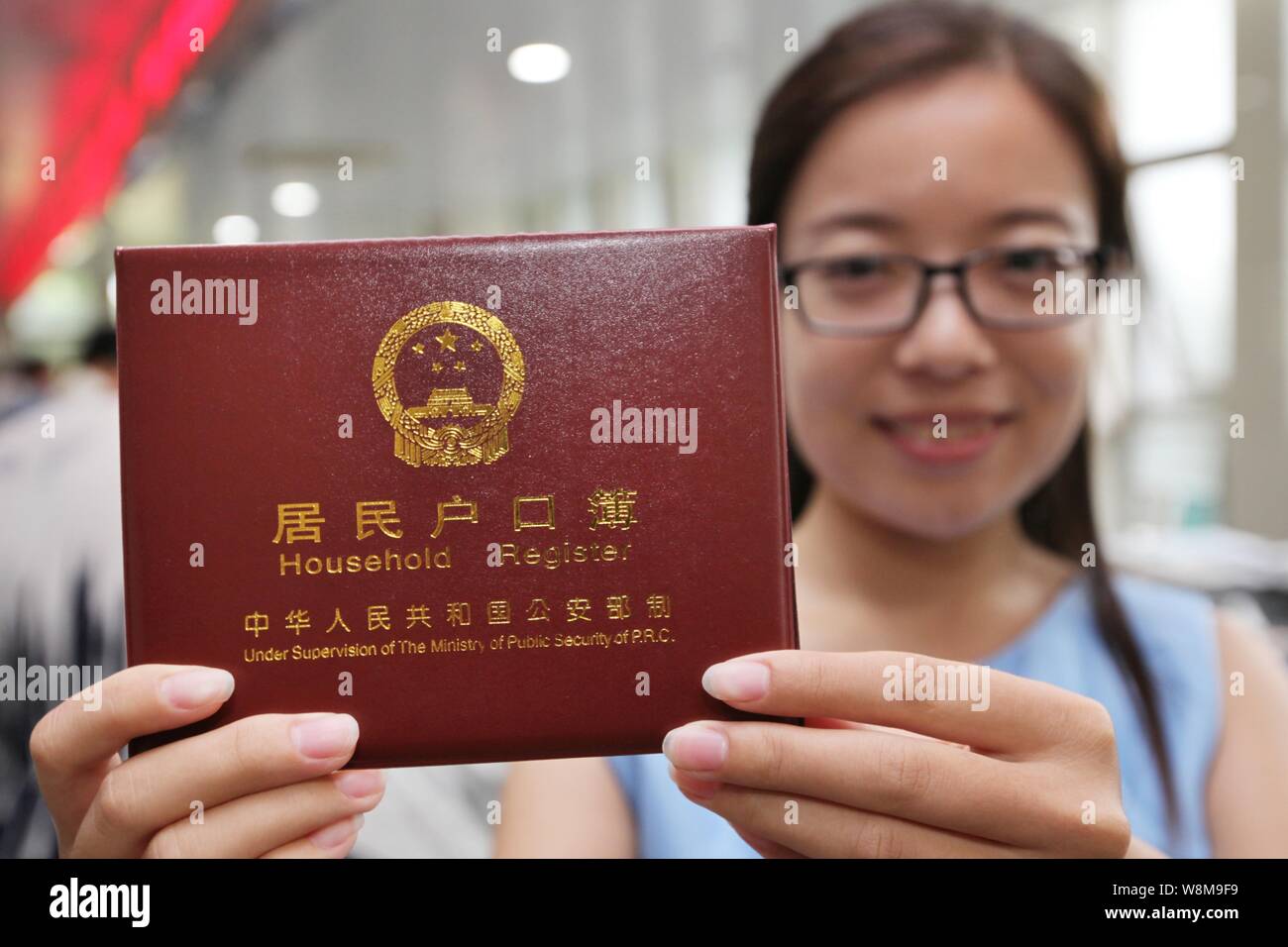 --FILE--A local Chinese resident shows her household register, also ...