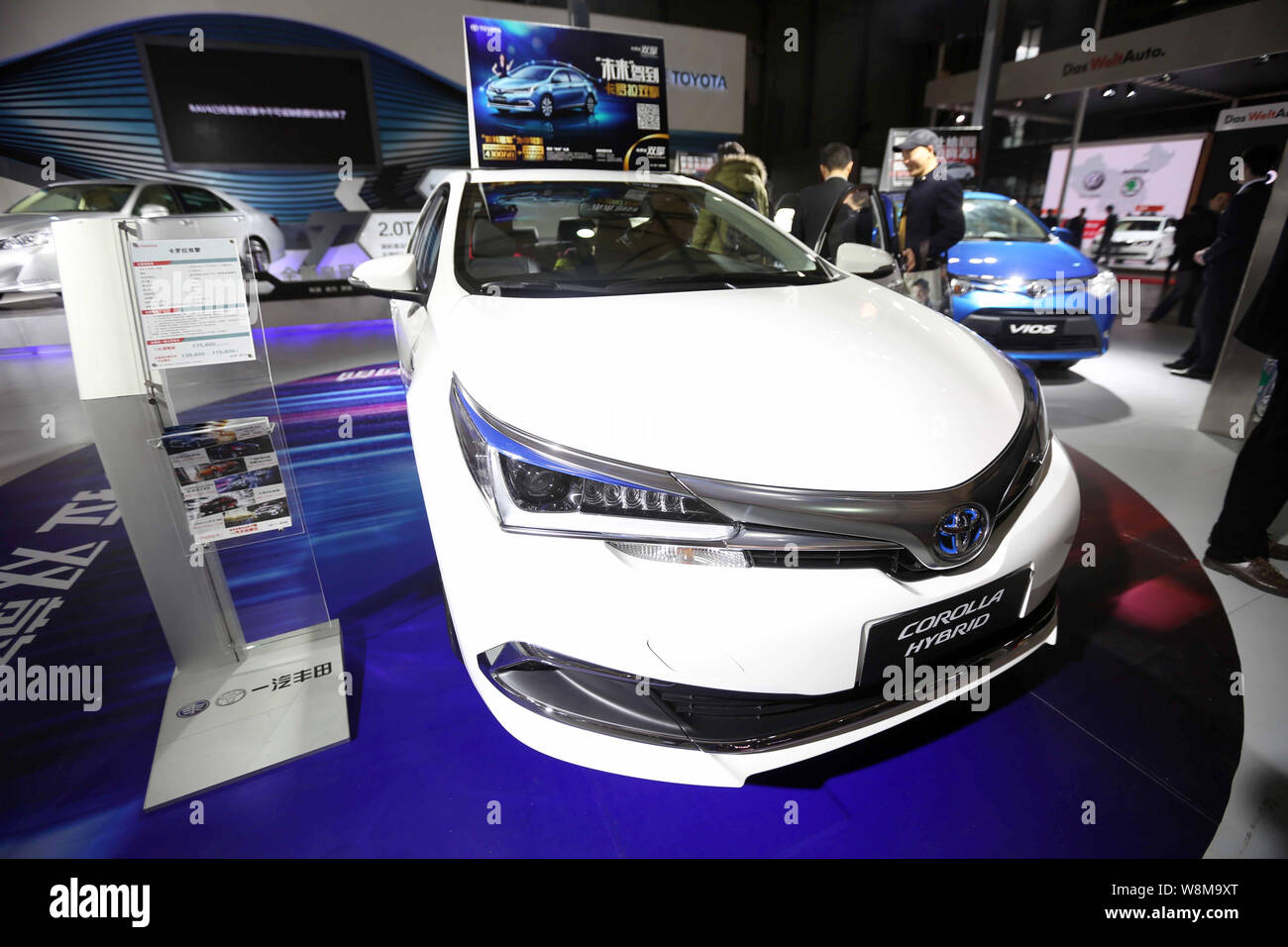 --FILE--Visitors try out or look at Toyota cars on display during an ...