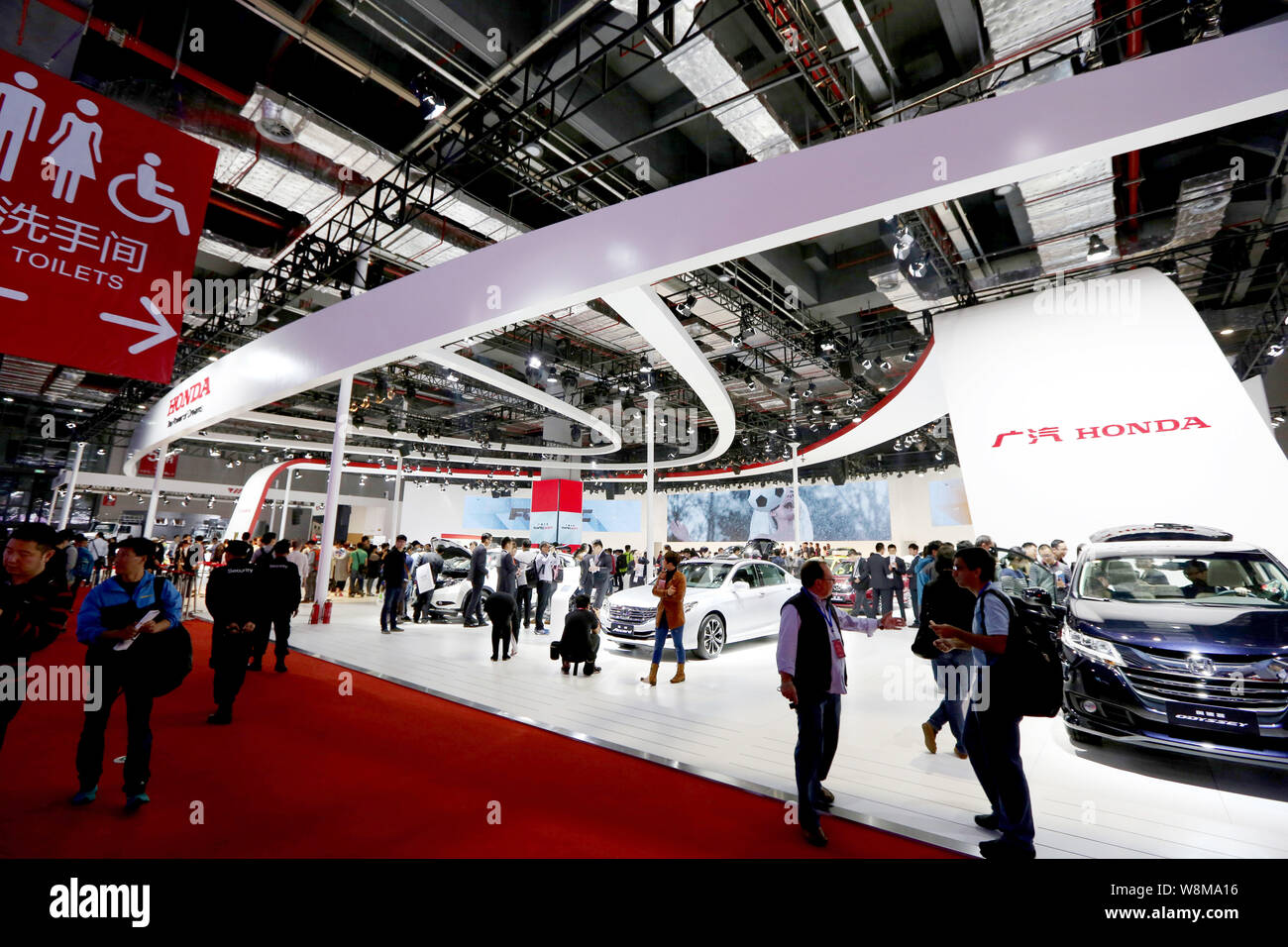 --FILE--Visitors look at Honda cars on display during the 16th Shanghai ...