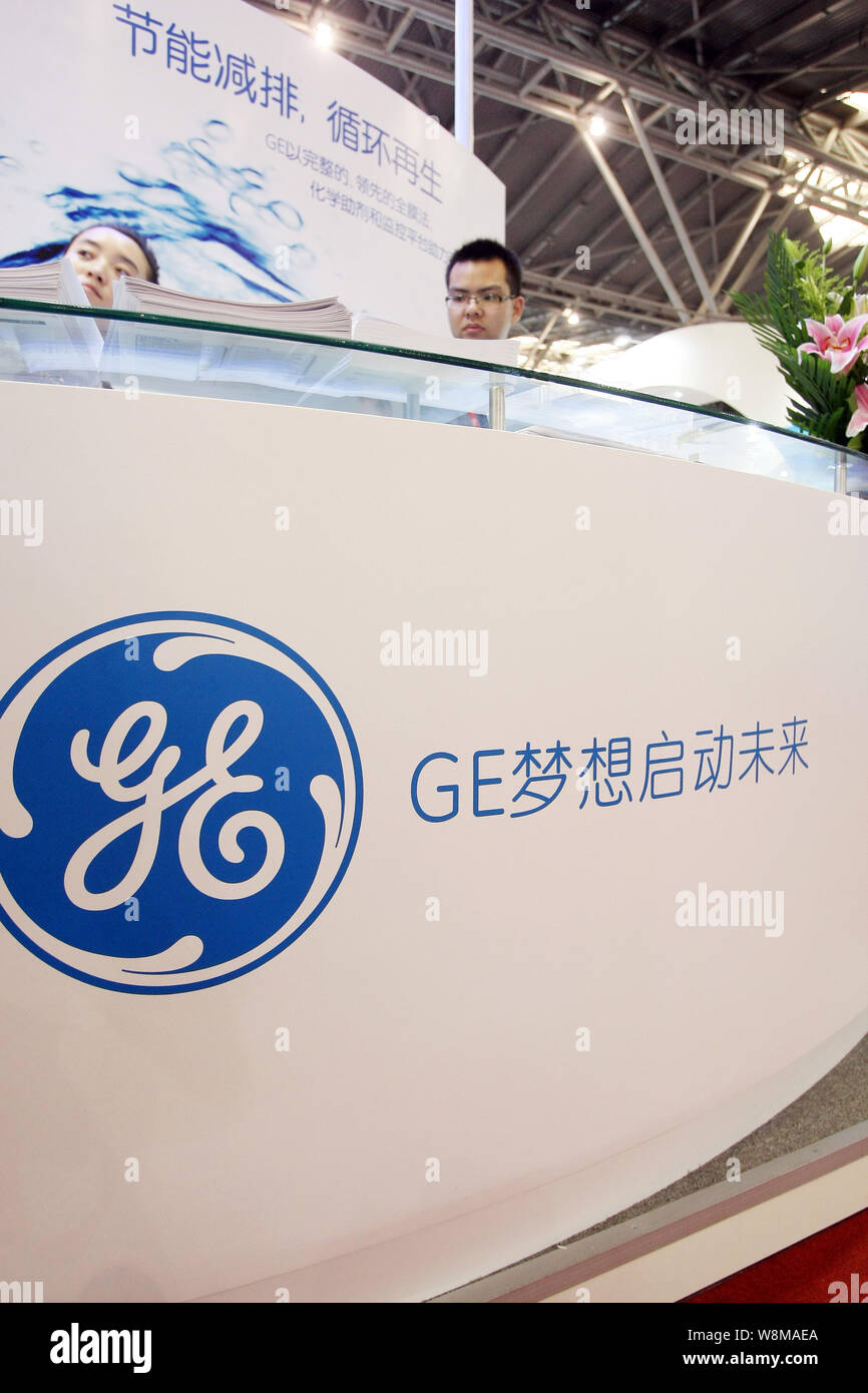 --FILE--Chinese employees work at the stand of General Electric (GE ...