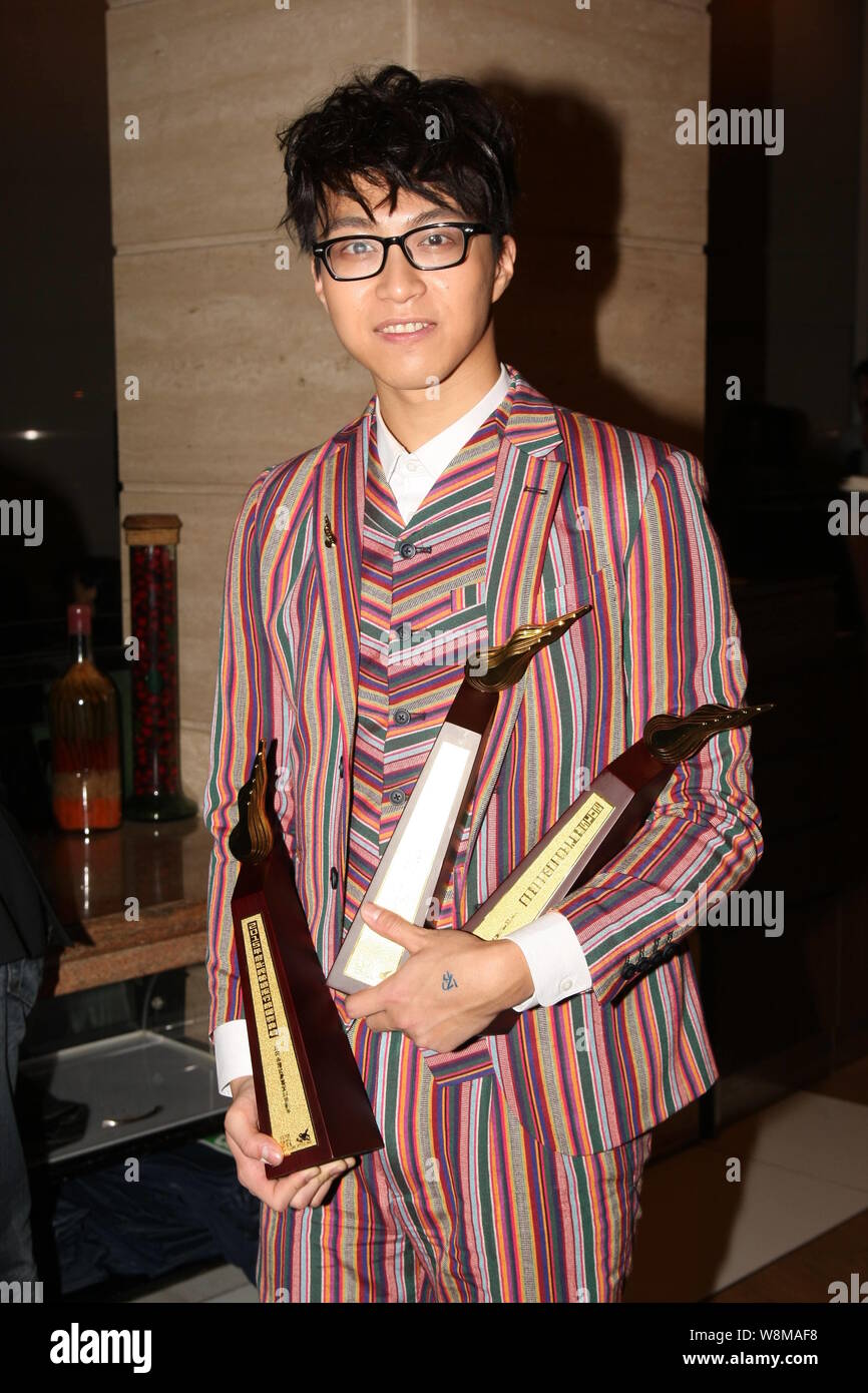 Hong Kong singer James Ng (Ng Yip Kwan) poses with trophys of the most ...