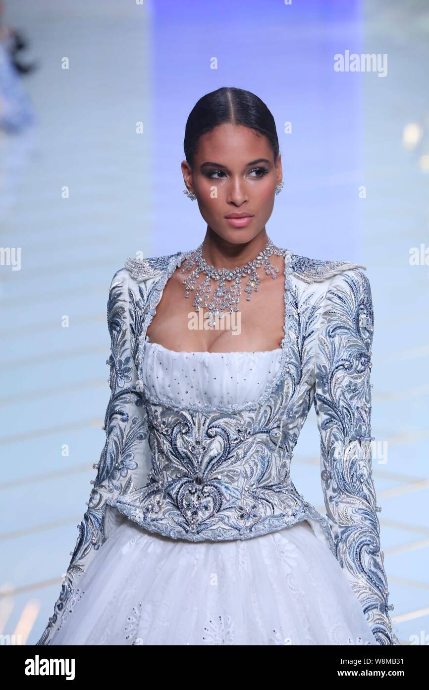A model displays a new creation at the Guo Pei fashion show during the ...