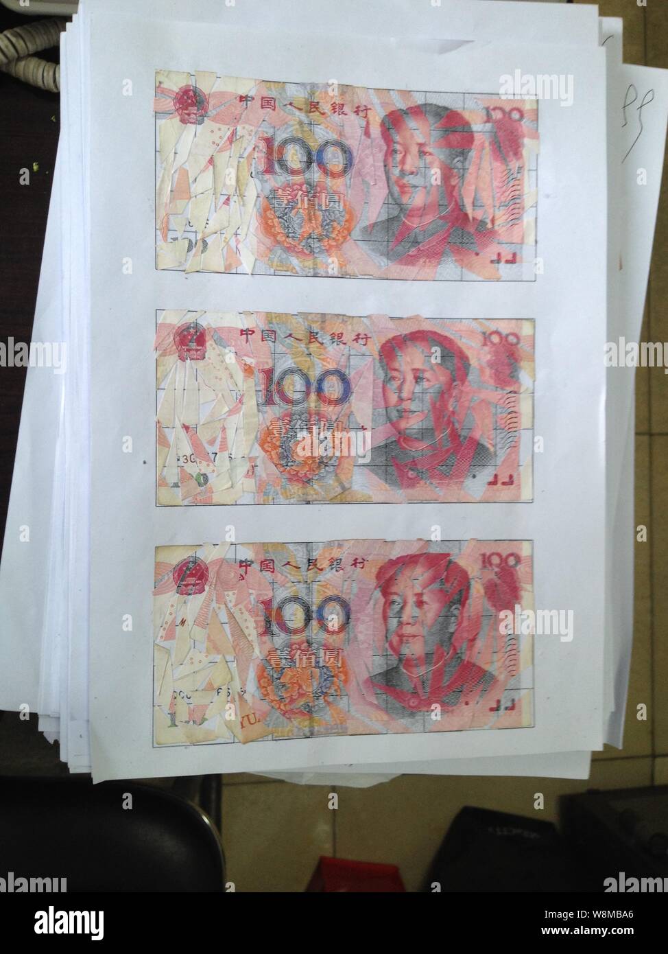 View of 100-yuan RMB banknotes pasted on blank pages which were put ...