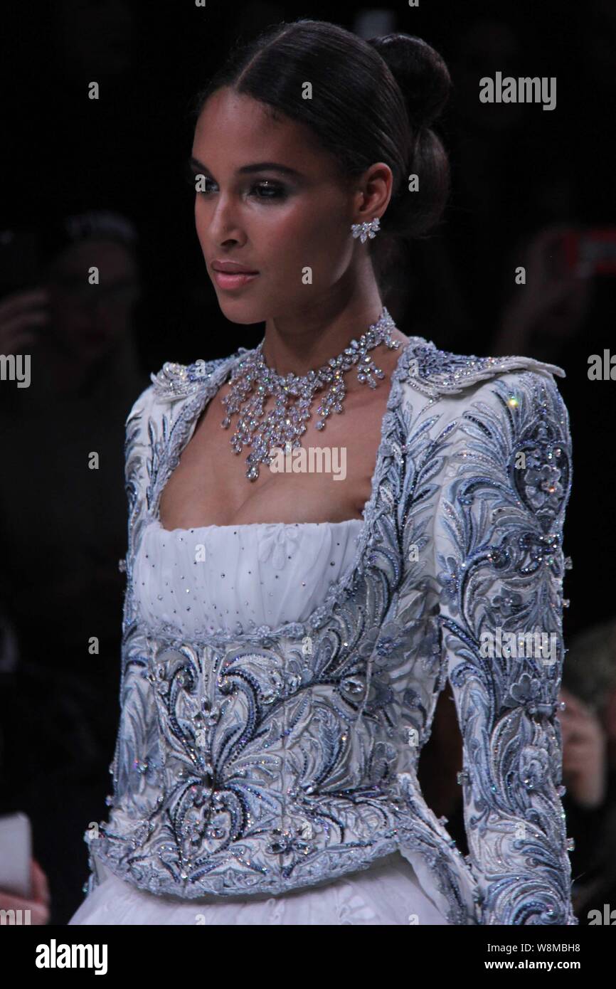 A model displays a new creation at the Guo Pei fashion show during the ...