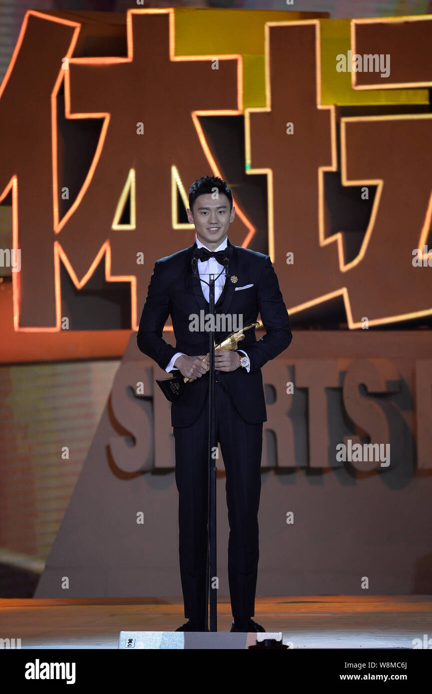 Chinese world swimming champion Ning Zetao holds his trophy for the ...
