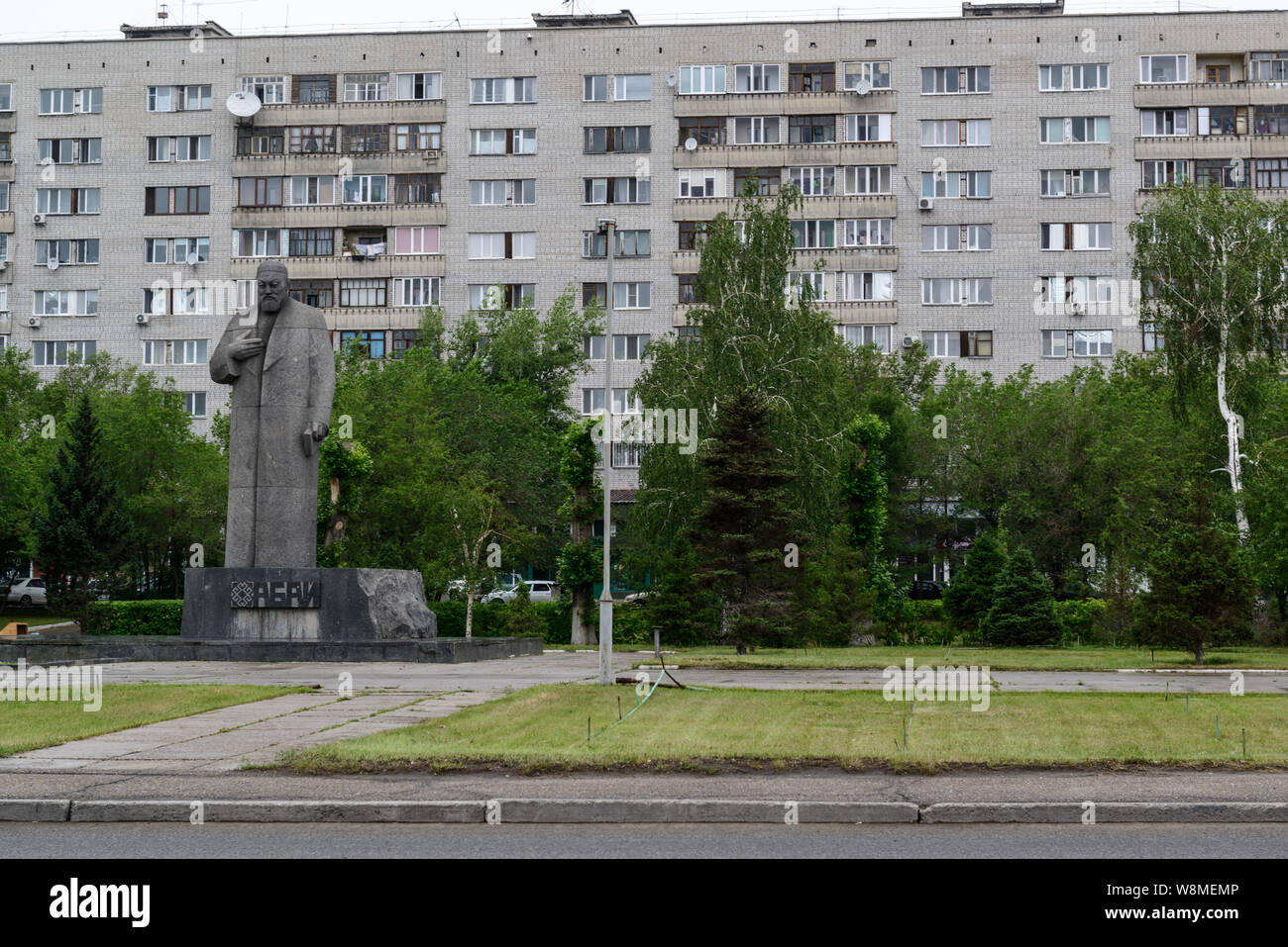 Soviet style statue in front of an appartment building in Semey ...