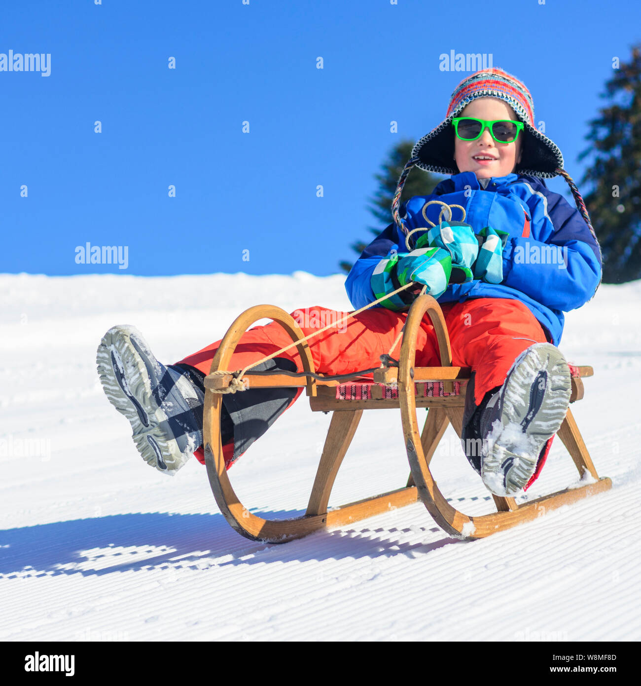 Funny afternoon in wintertime on sleigh slope Stock Photo - Alamy