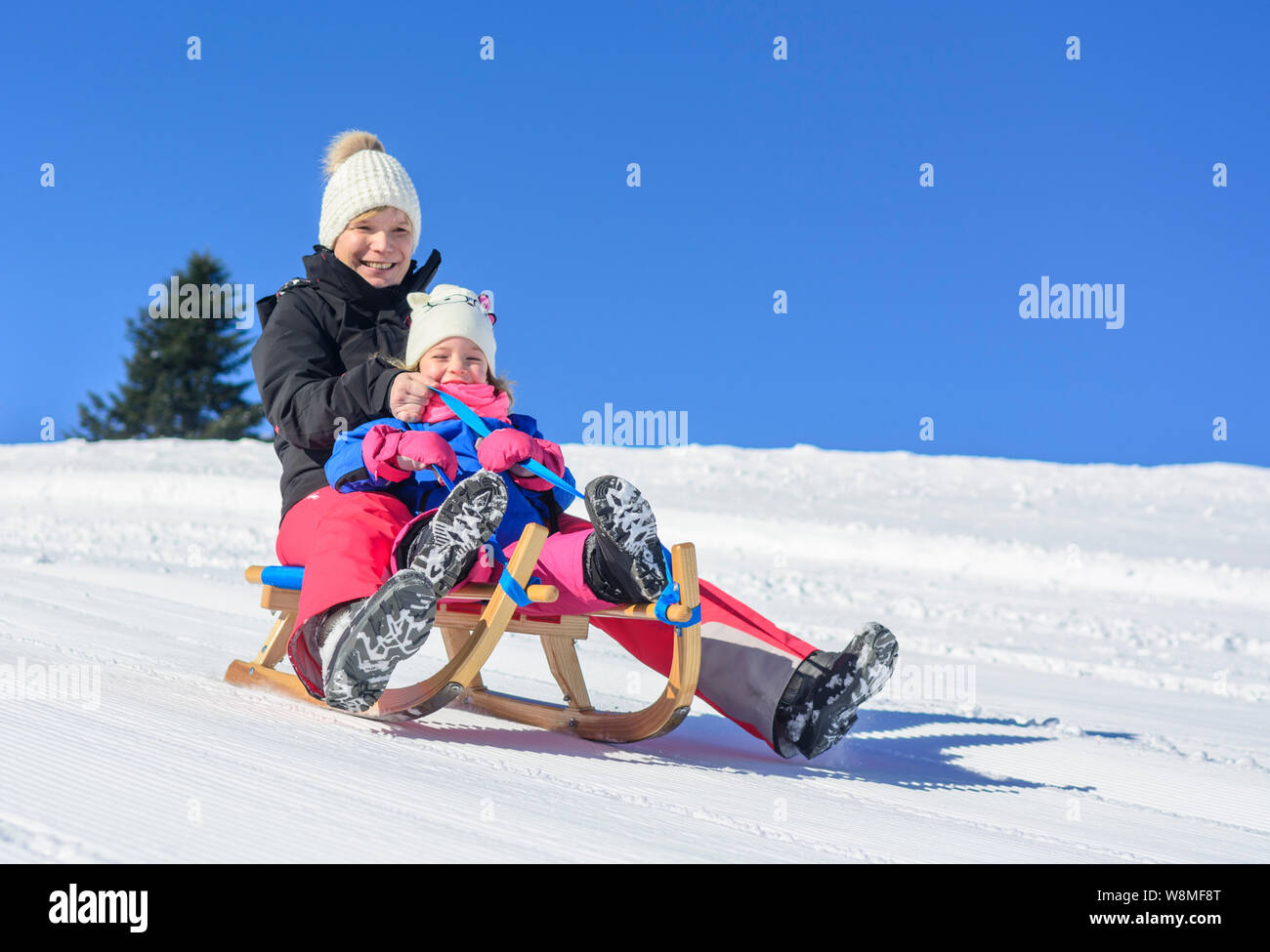 Funny afternoon in wintertime on sleigh slope Stock Photo - Alamy