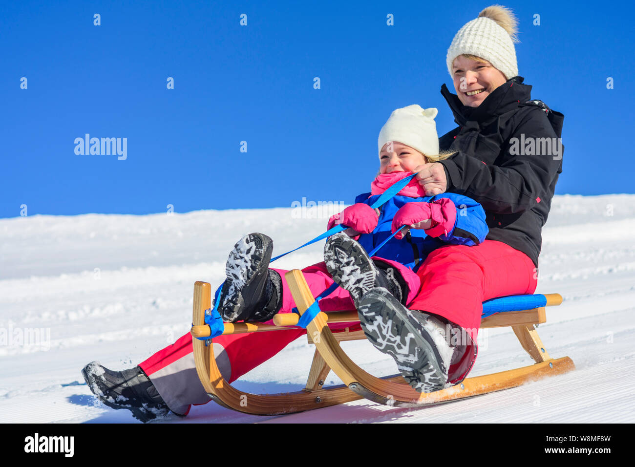 Funny afternoon in wintertime on sleigh slope Stock Photo - Alamy