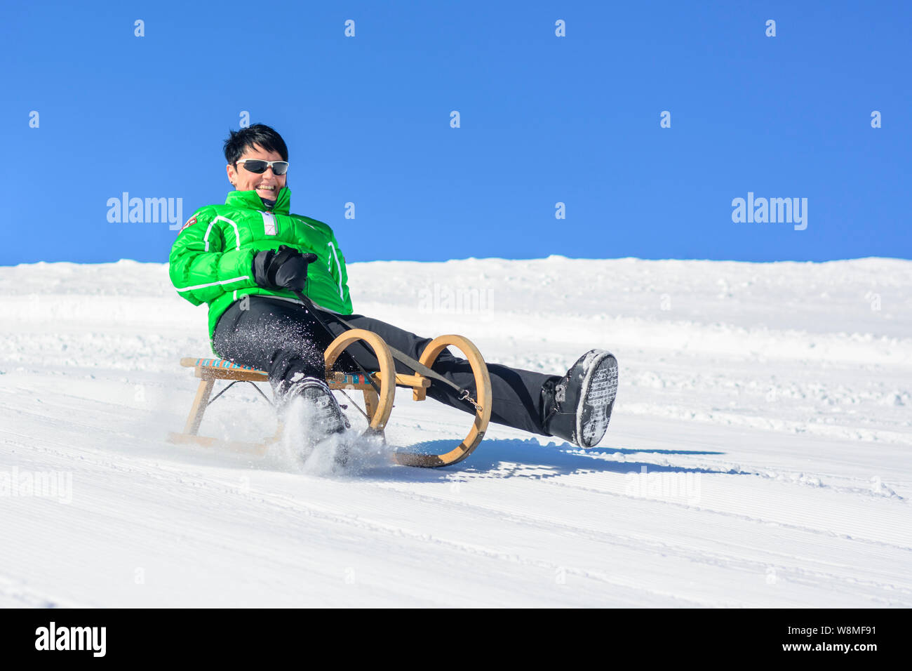 Funny afternoon in wintertime on sleigh slope Stock Photo - Alamy