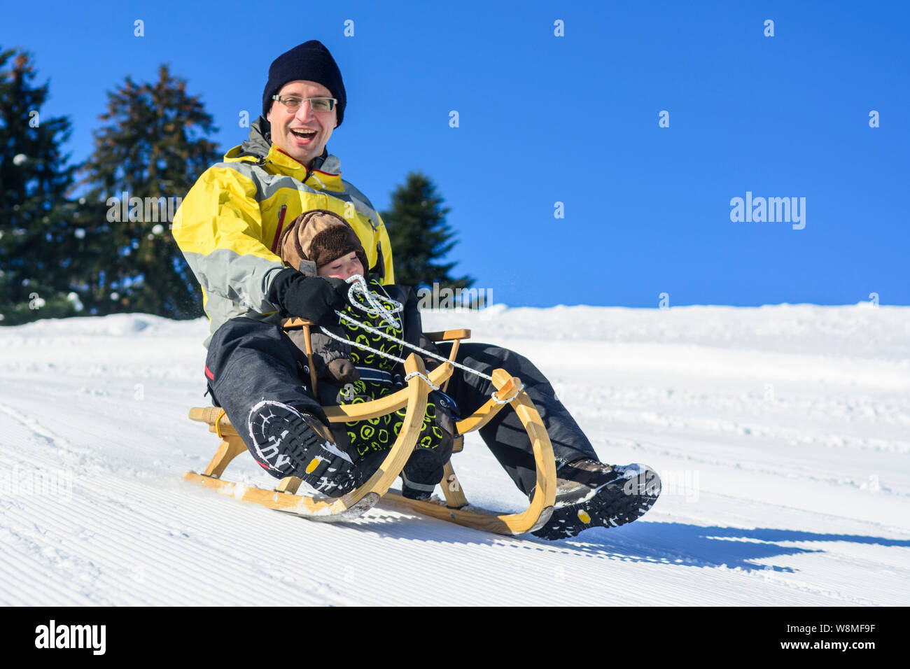 Funny afternoon in wintertime on sleigh slope Stock Photo - Alamy