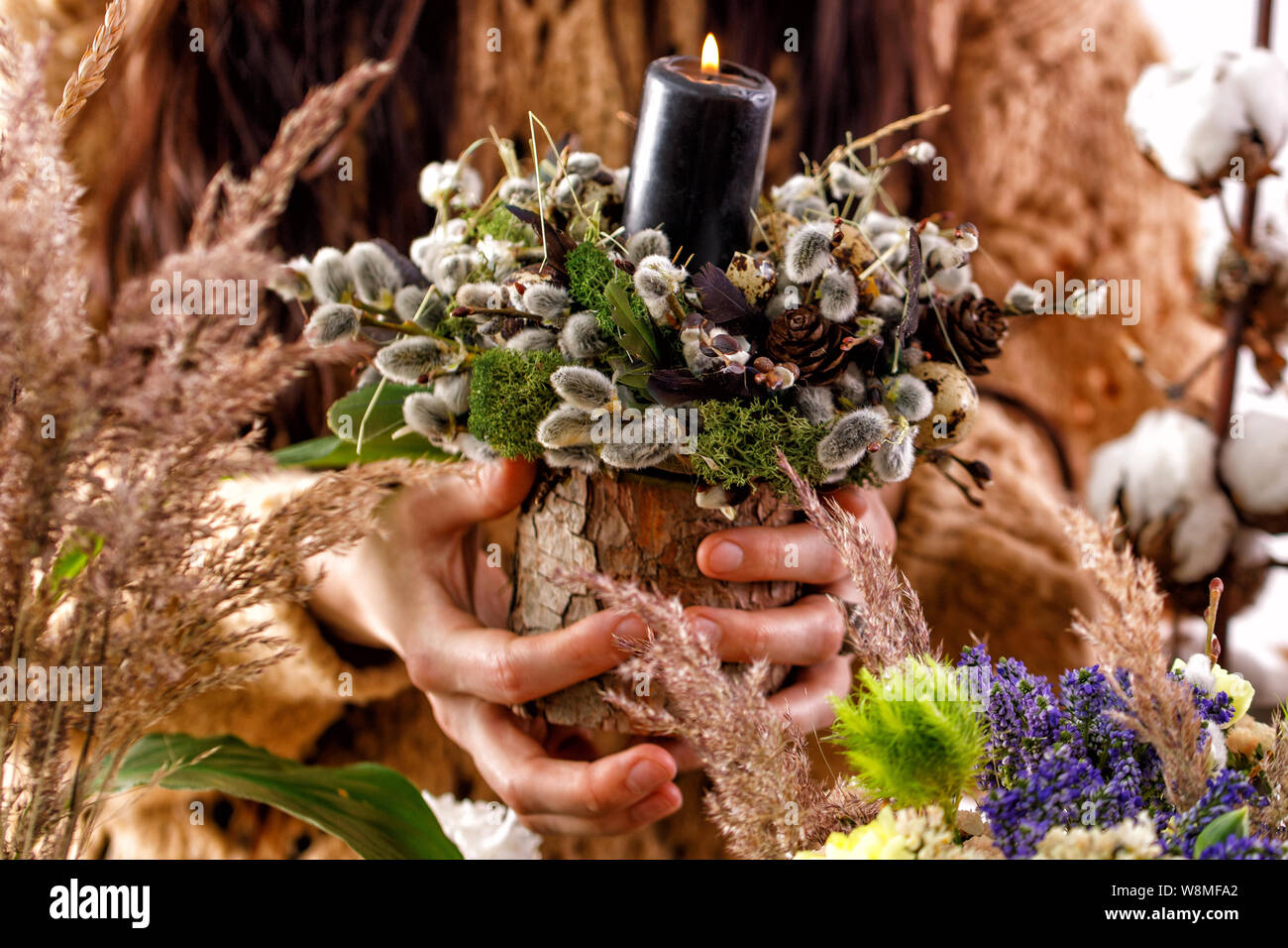 Dried flowers and willow branches in the hands of a girl. decorations ...