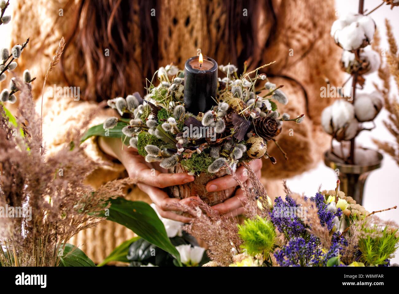 Dried flowers and willow branches in the hands of a girl. decorations ...