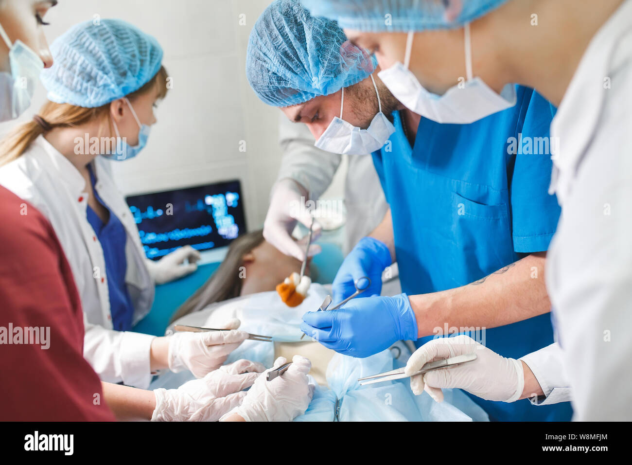 Group of surgeons at work operating in surgical theatre. Resuscitation ...