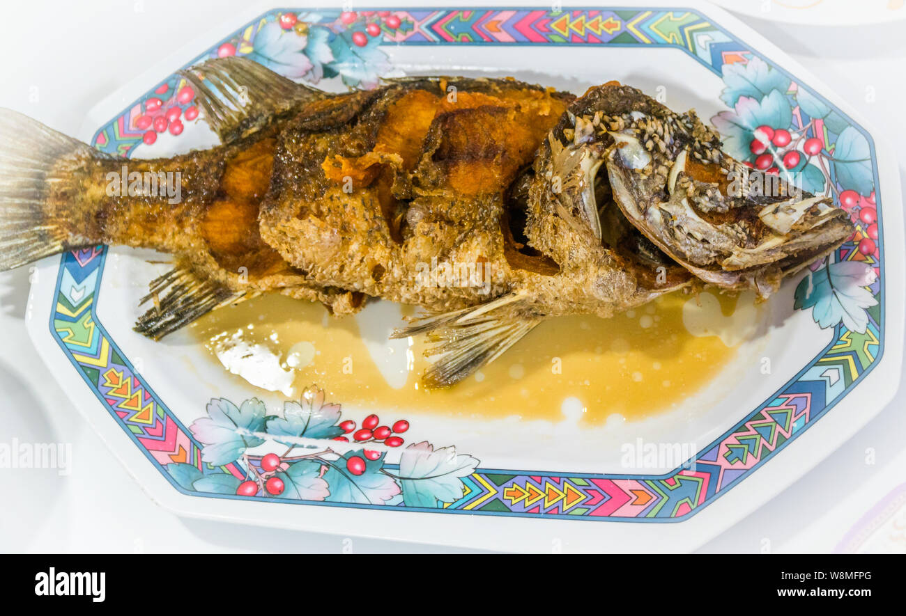 Deep fried snapper with sweet fish sauce, Thai style dish Stock Photo ...