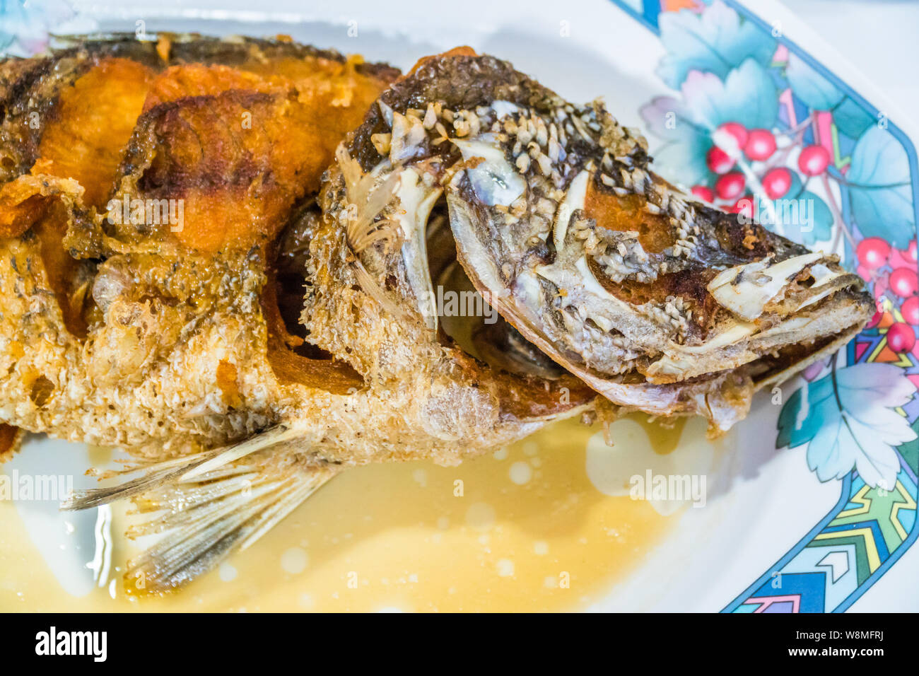 Fried white snapper with fish sauce,Thai food Stock Photo - Alamy
