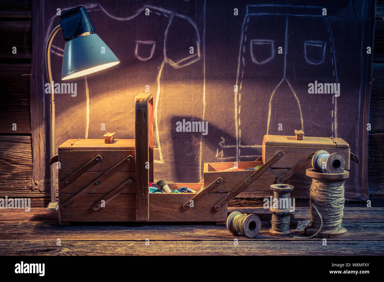 Materials, threads and needles in sewing workshop Stock Photo - Alamy