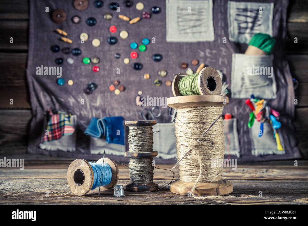 Old threads and needles in sewing workshop Stock Photo - Alamy