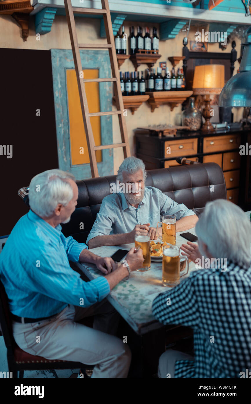 Top view of three men talking and drinking beer Stock Photo - Alamy