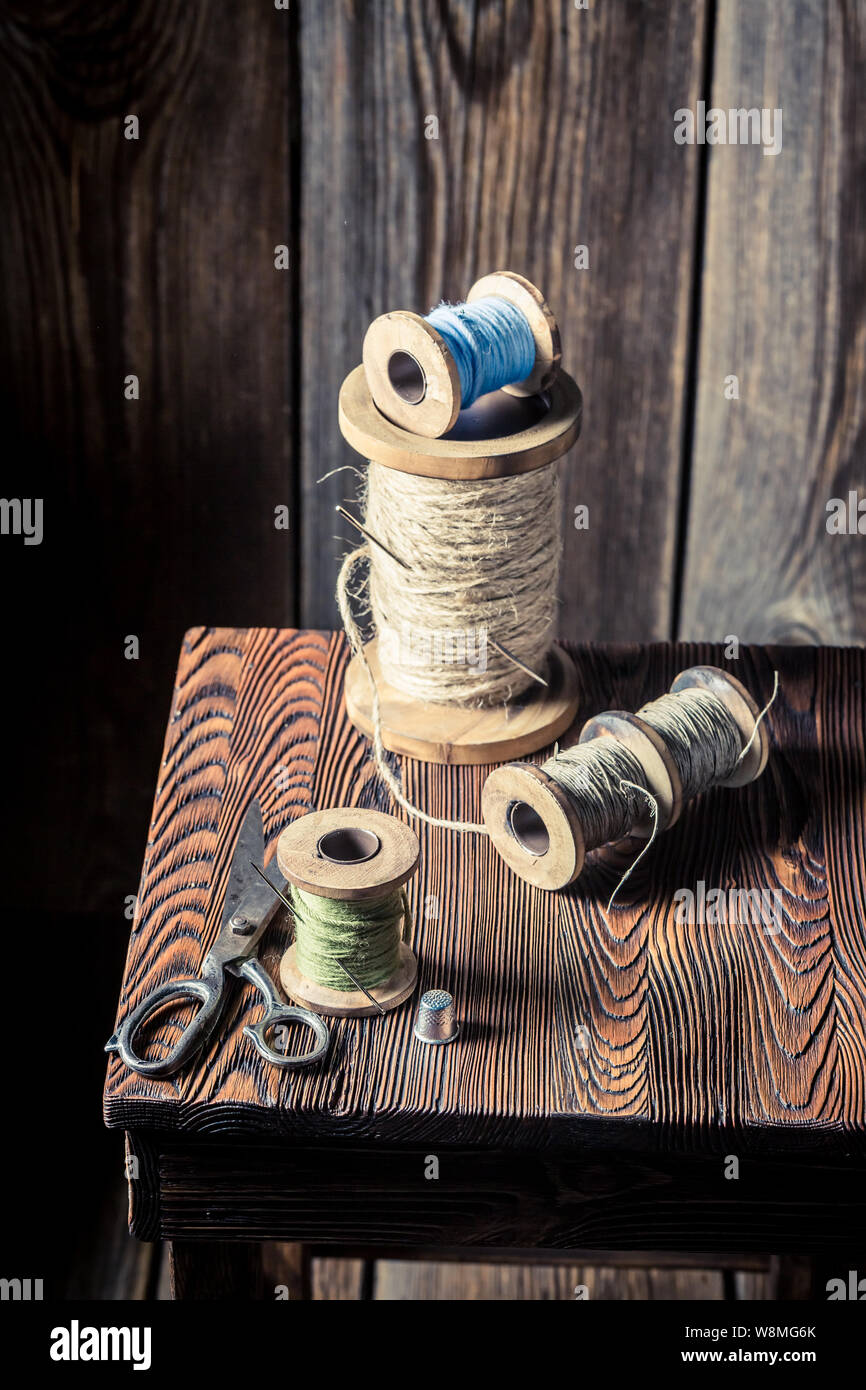 Sewing vintage table with scissors and threads Stock Photo - Alamy