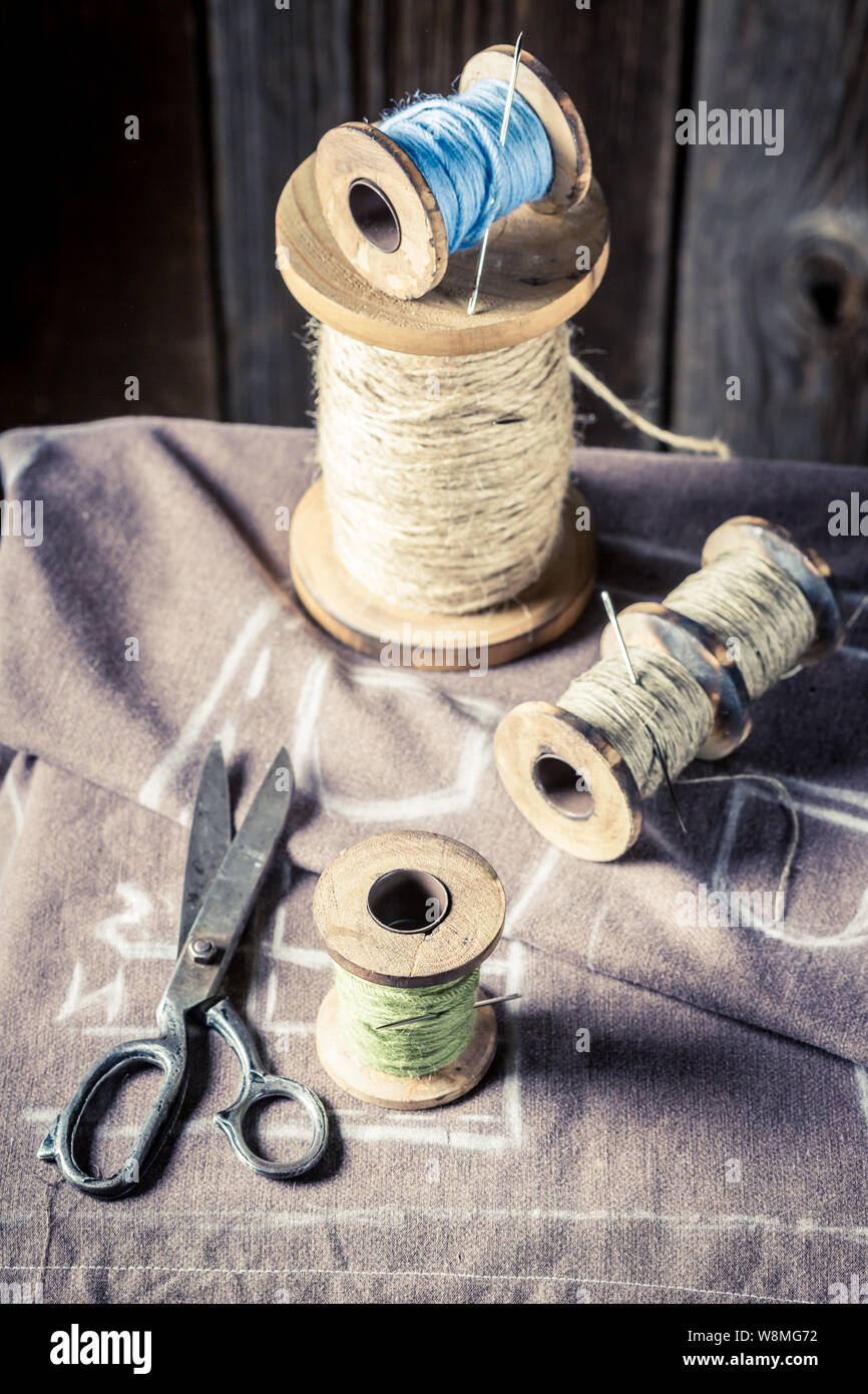 Closeup of sewing table with scissors, cloth and threads Stock Photo ...