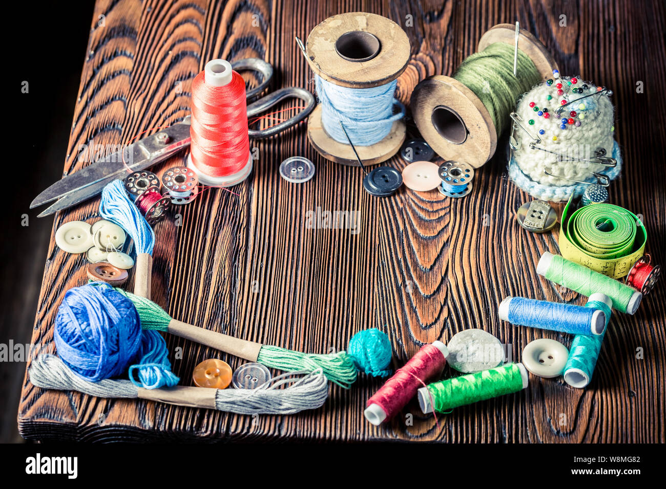 Vintage scissors, needle and threads as background Stock Photo - Alamy