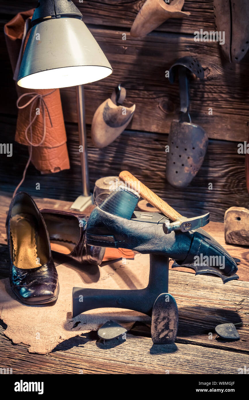 Rustic shoemaker workshop with tools, leather and shoes Stock Photo - Alamy