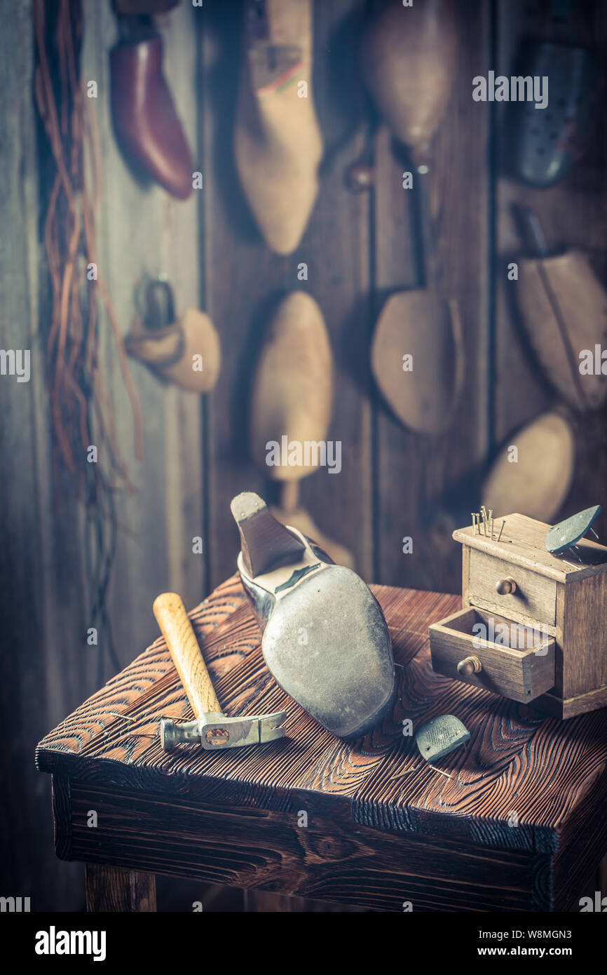Closeup of shoemaker workplace with tools, shoes and laces Stock Photo ...