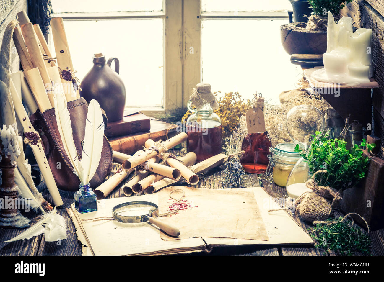 Rustic witch workshop with scrolls and plants Stock Photo - Alamy