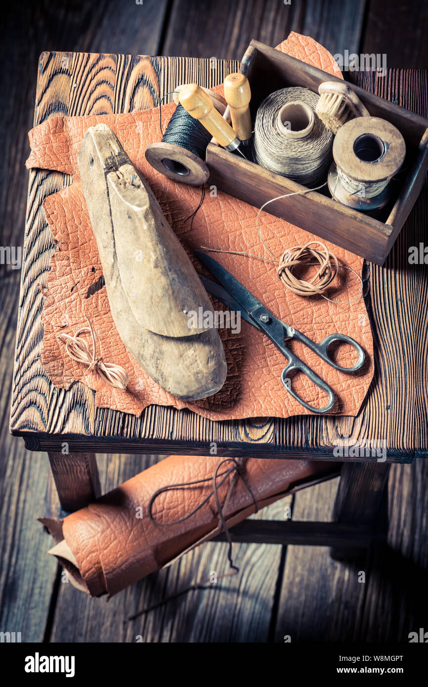 Top view of cobbler workshop with tools, shoes and leather Stock Photo - Alamy