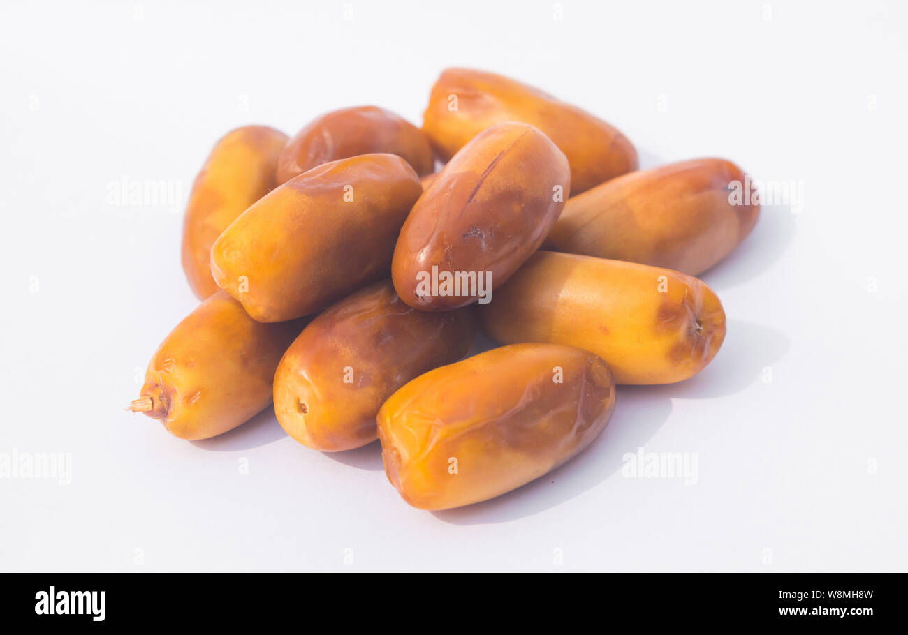 close up of fresh riped delicious yellow dates isolated on white ...