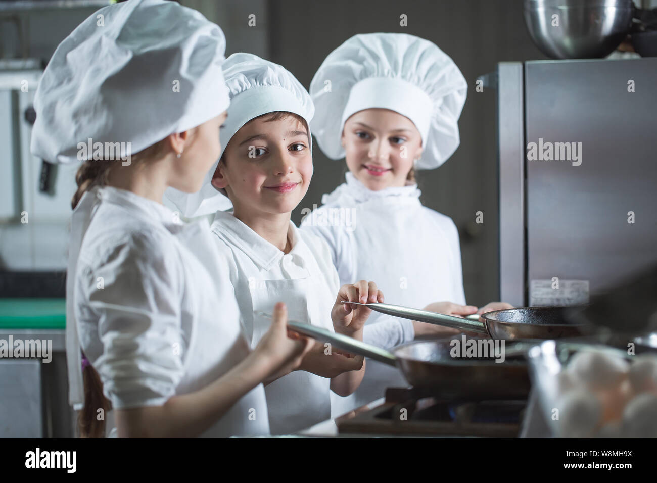 Children cook eggs in the kitchen at the Restaurant Stock Photo - Alamy