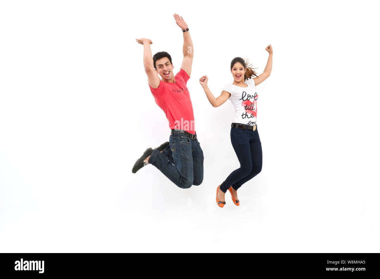 Young couple jumping in air Stock Photo - Alamy