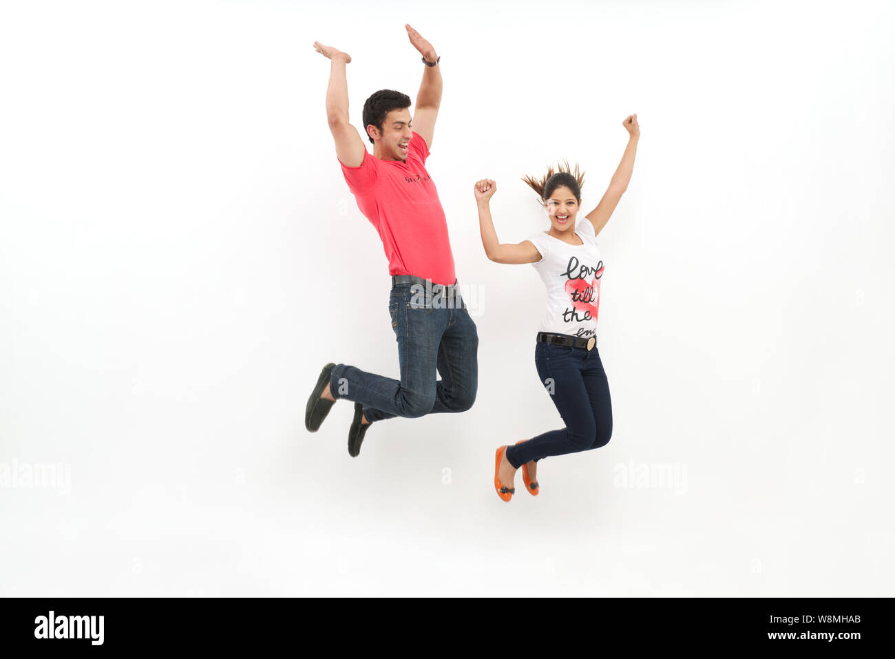 Young couple jumping in air Stock Photo - Alamy