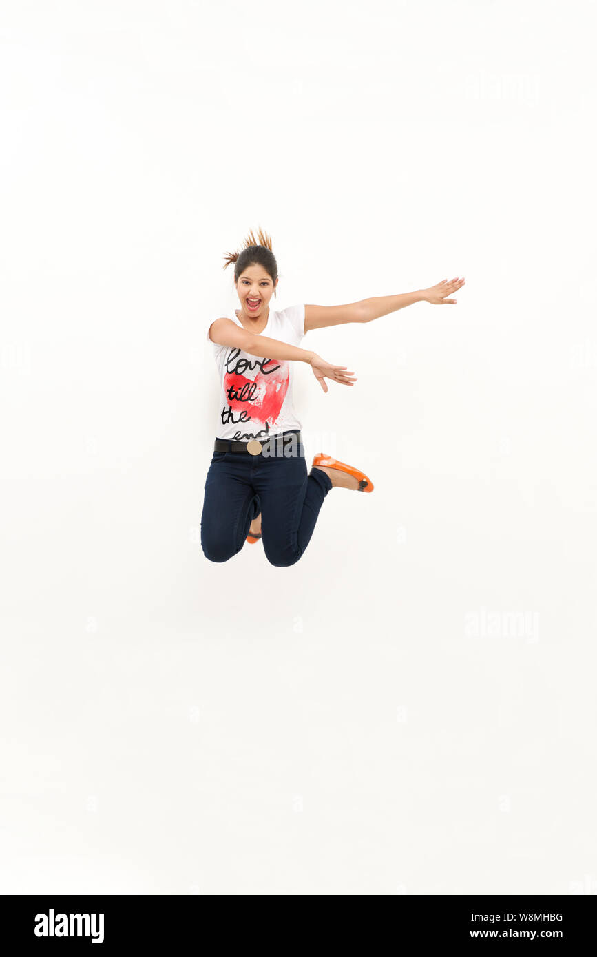 Young woman jumping in air Stock Photo - Alamy