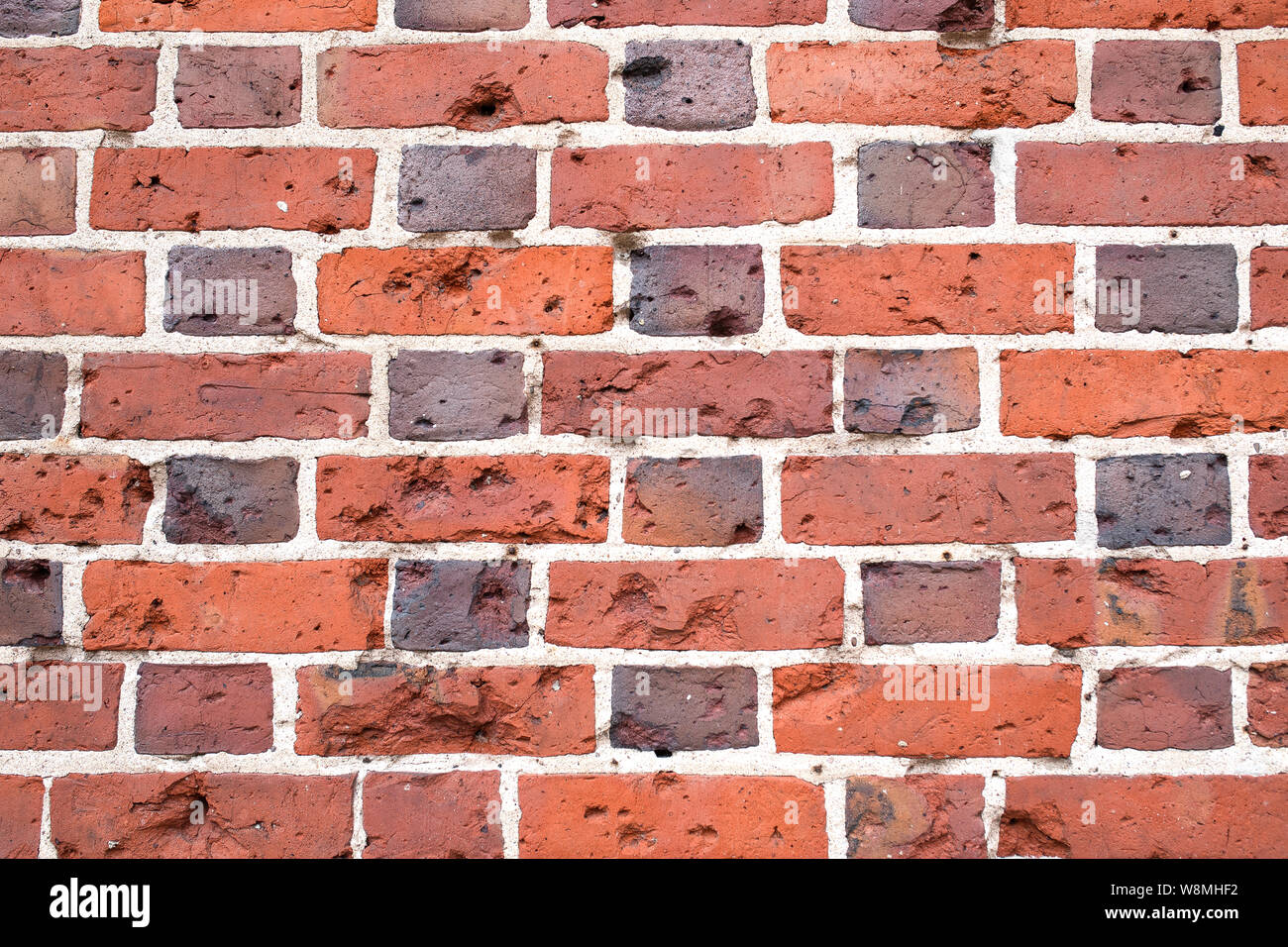 Bullets marks on the red bricks wall. Old, medieval castle wall in ...