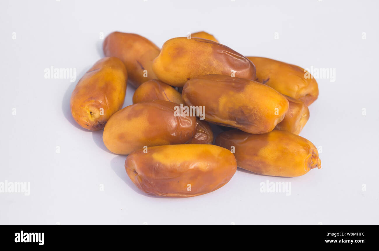 close up of fresh riped delicious yellow dates isolated on white ...