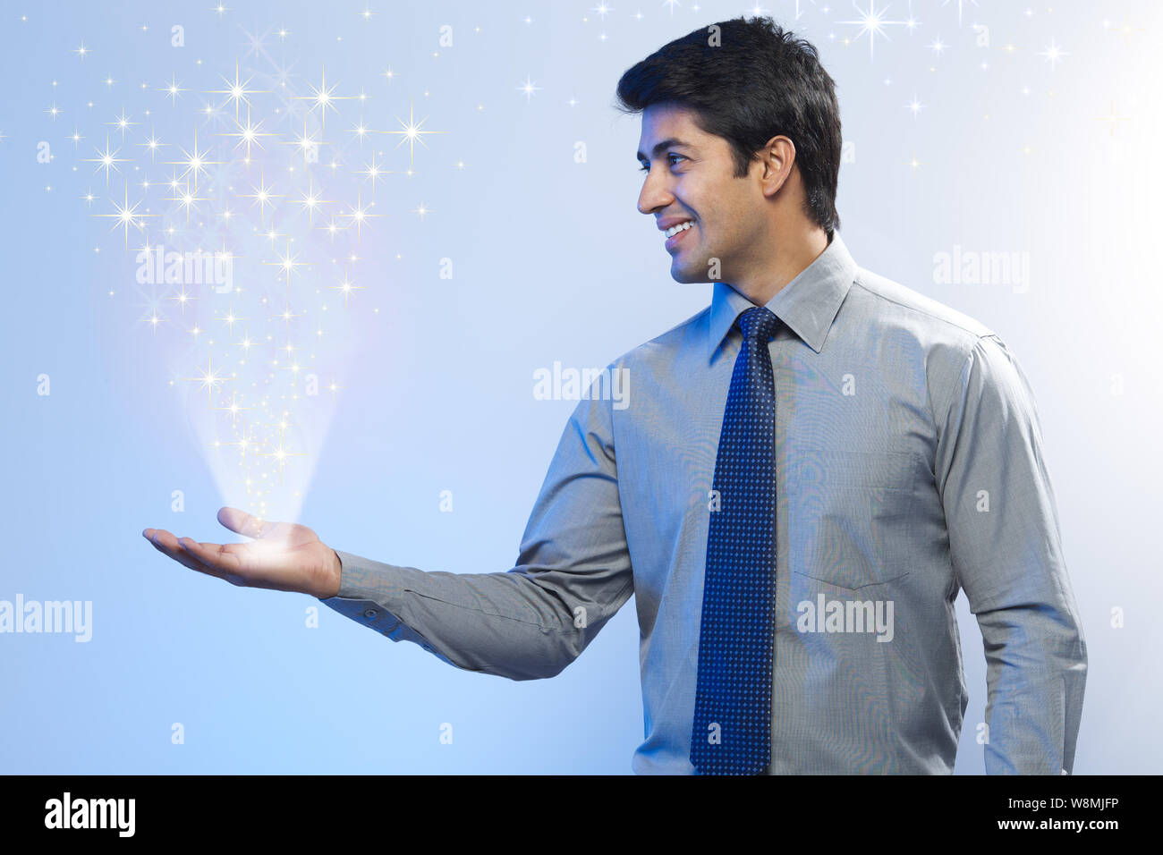 Lights emitting from the hand of a businessman Stock Photo - Alamy