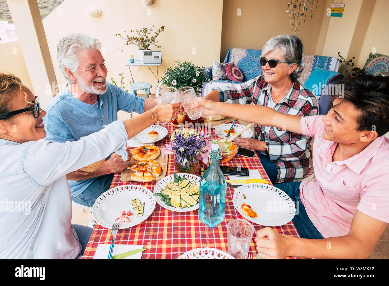 Group of mixed generations people have fun together during lunch at ...