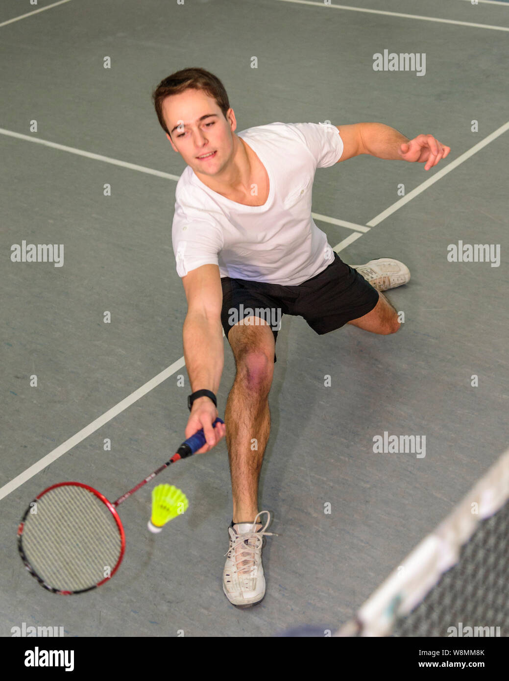 Badminton game scene in sports hall, a lot of effort and commitment ...