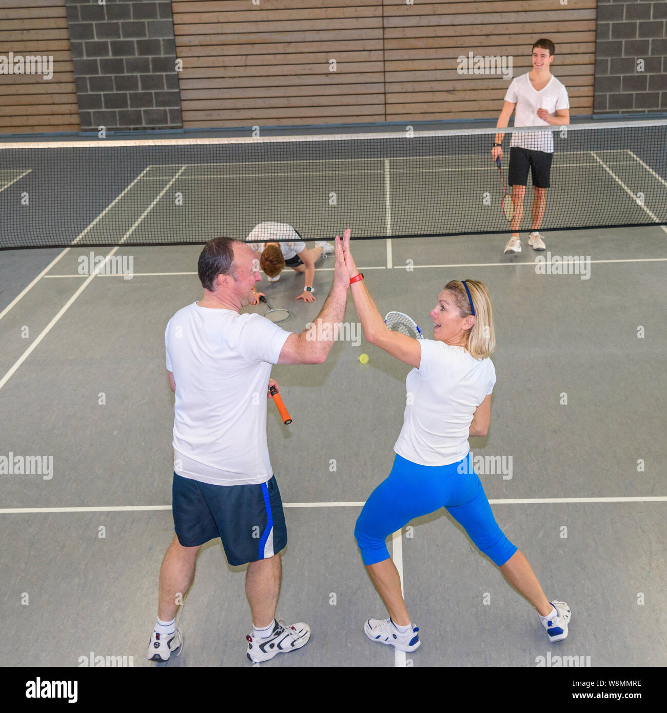 Badminton game scene in sports hall, a lot of effort and commitment ...